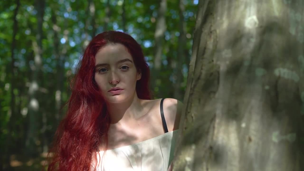 Woman Standing Behind A Tree - Stock Video | Motion Array