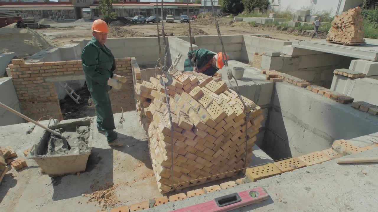 Workers Unloading Bricks From A... - Stock Video | Motion Array
