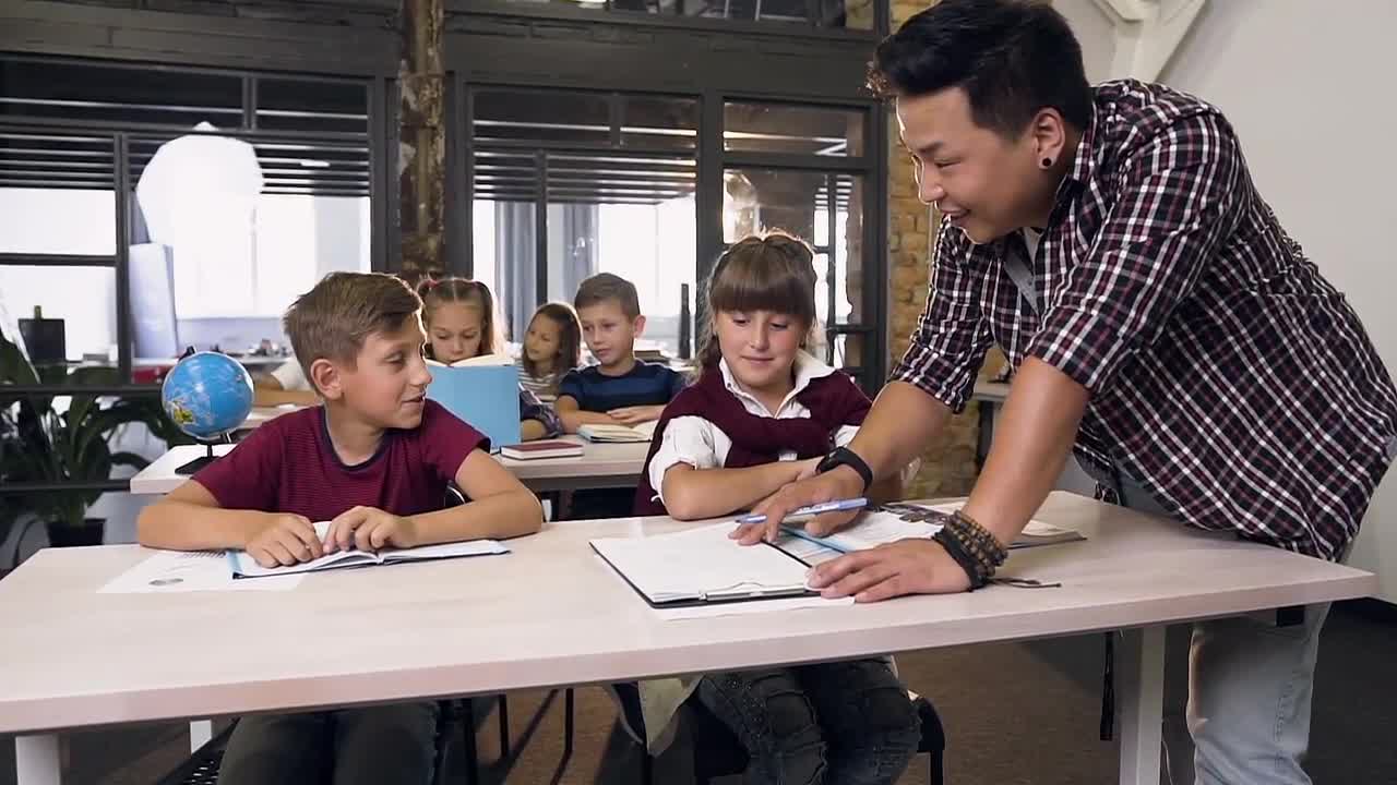 Elementary School Teacher With Students - Stock Video | Motion Array
