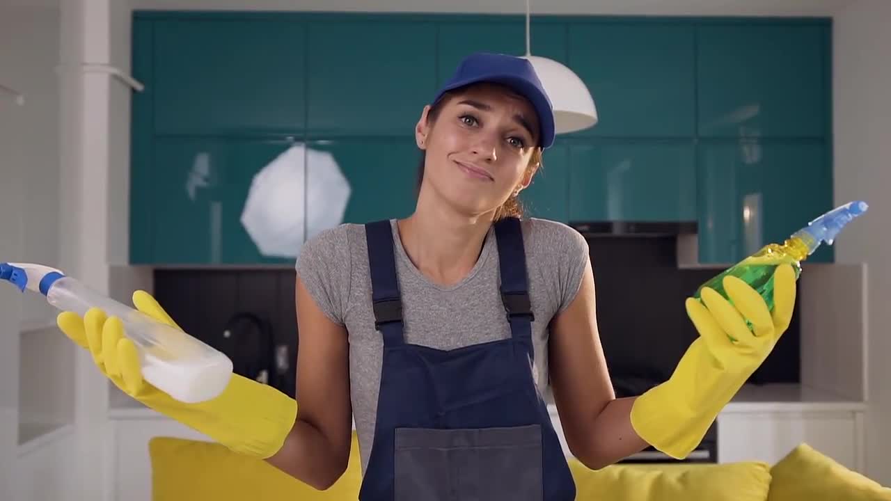 Confused Housekeeper With Cleaning Spray - Stock Video | Motion Array