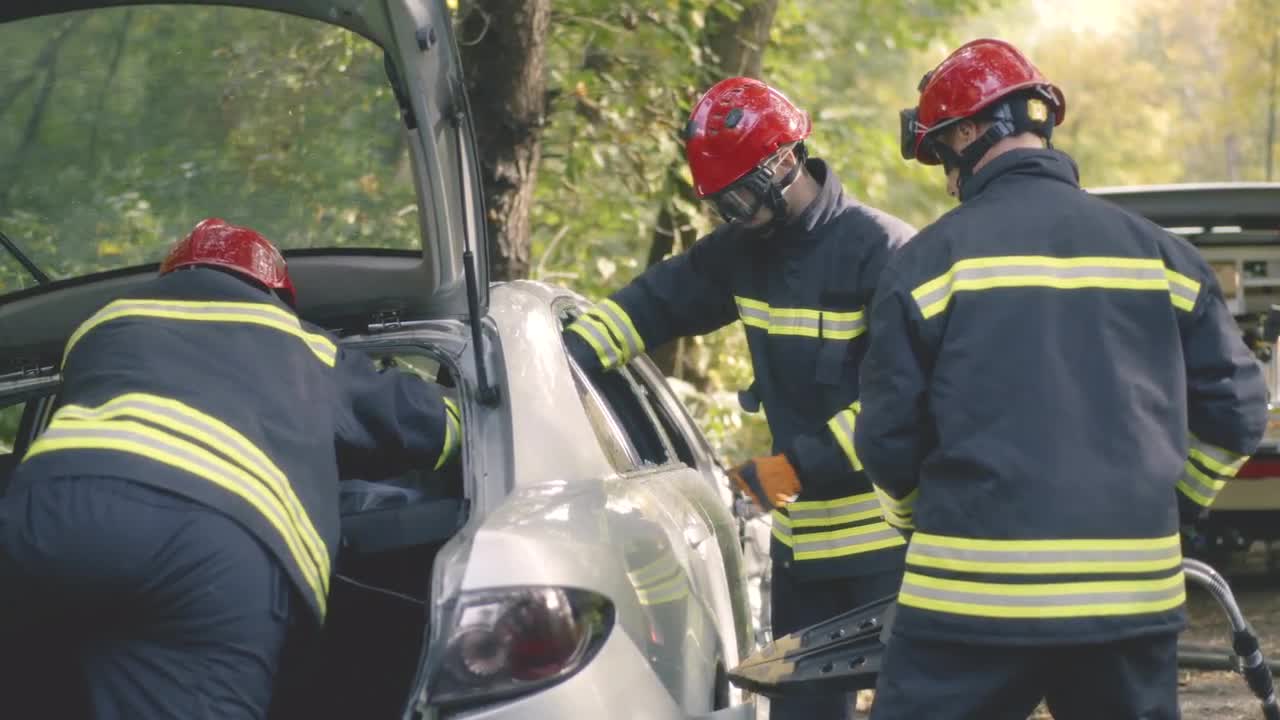 Firemen Breaking Window Of Car - Stock Video | Motion Array