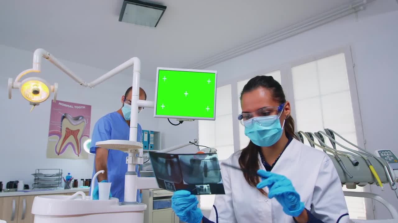 Dentist Showing Green Screen Monitor - Stock Video | Motion Array