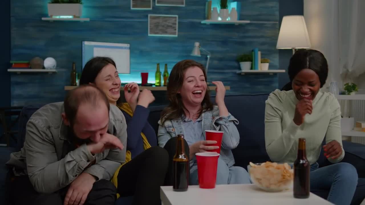 Friends Laughing Watching TV - Stock Video | Motion Array