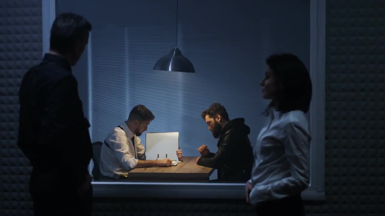 Watching An Interrogation - Stock Video | Motion Array