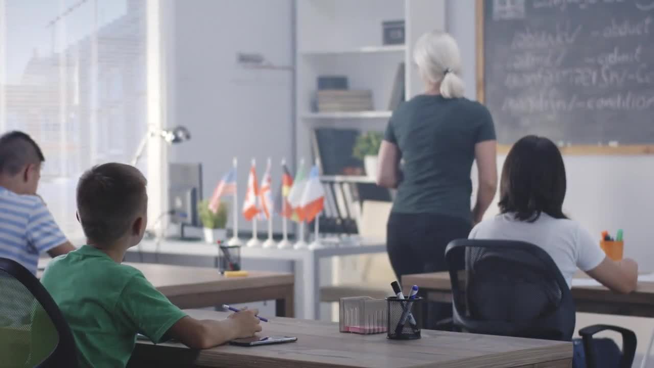 Teacher Handing Out Papers - Stock Video | Motion Array