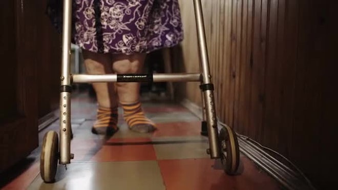 Old Woman Walking With Walker - Stock Video | Motion Array