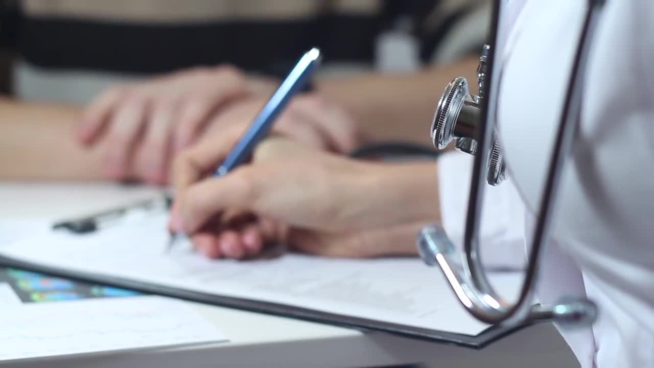 doctor-writing-a-medical-report-stock-video-motion-array