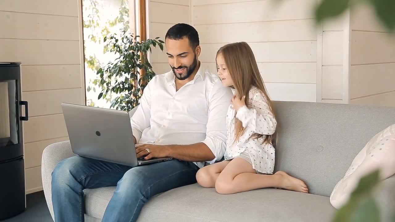 Father And Daughter Using Laptop - Stock Video | Motion Array