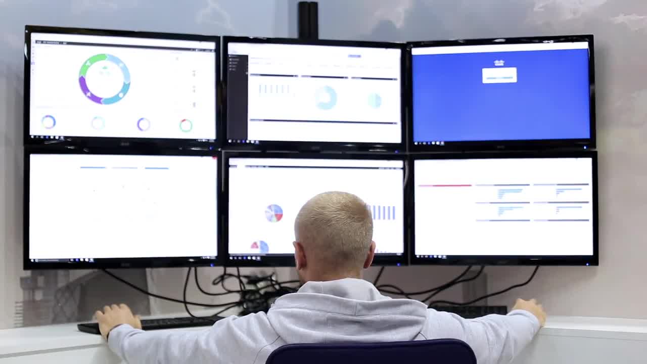 Man Working With Multiple Monitors - Stock Video | Motion Array