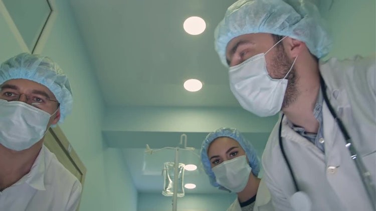 Surgeons Looking At Patient - Stock Video | Motion Array