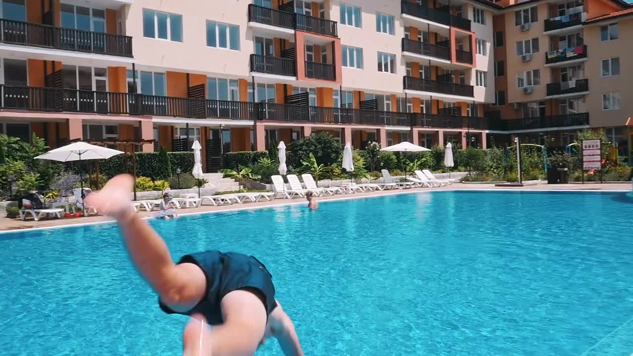 Man Jumping Into Pool - Stock Video | Motion Array