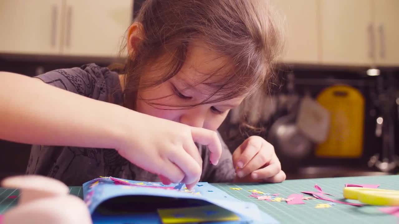 Little Girl Gluing Colored Paper - Stock Video | Motion Array