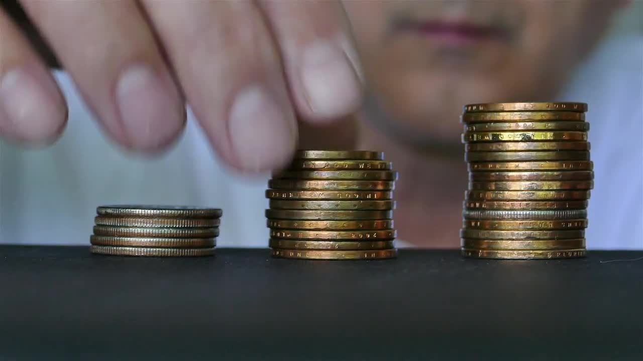 Man Taking Coins From Pile - Stock Video | Motion Array
