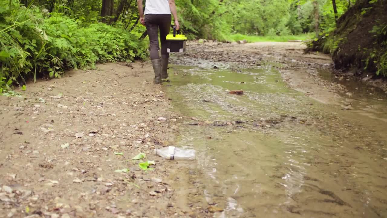 Ecologist Walks Along Stream - Stock Video | Motion Array