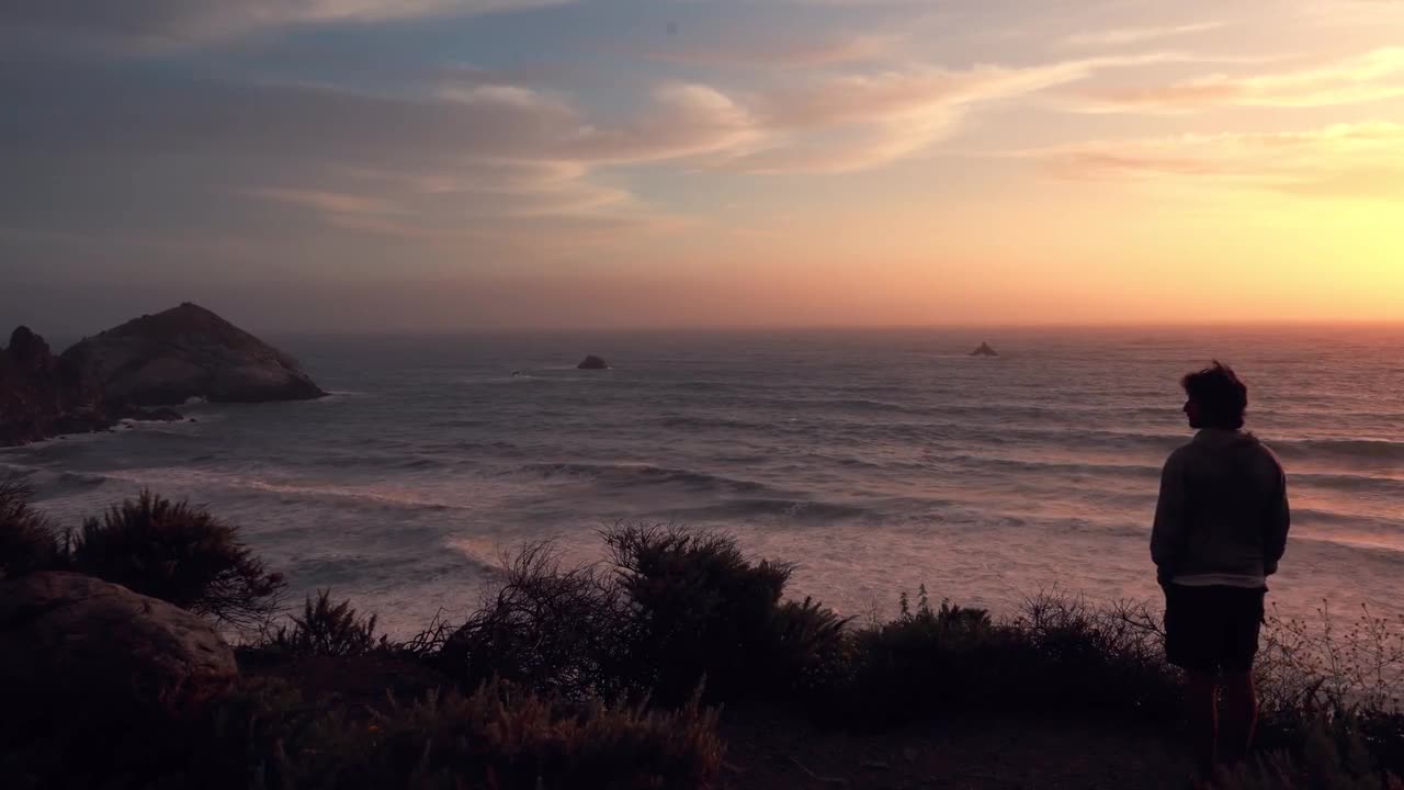 Man Watching Ocean Sunset - Stock Video | Motion Array
