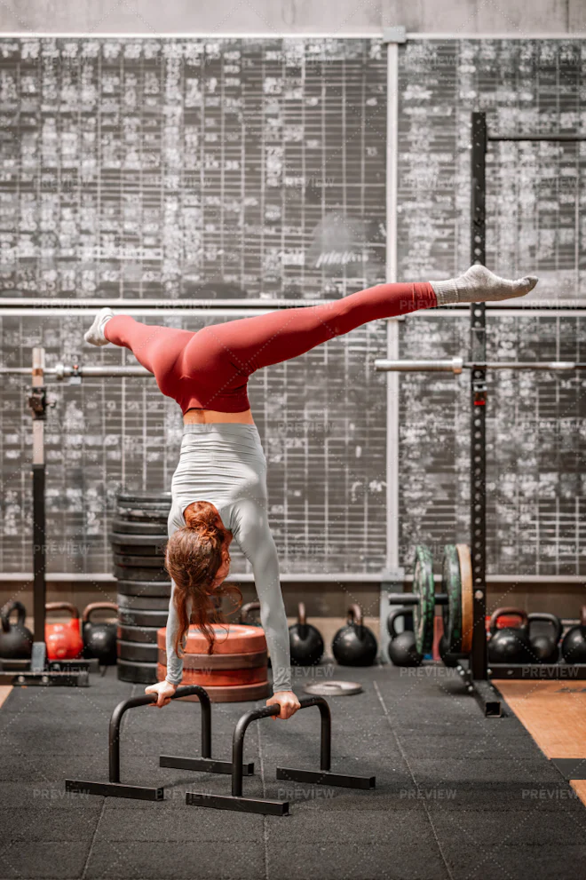 Woman Performing Straddle Handstand Calisthenics Exercise - Stock ...