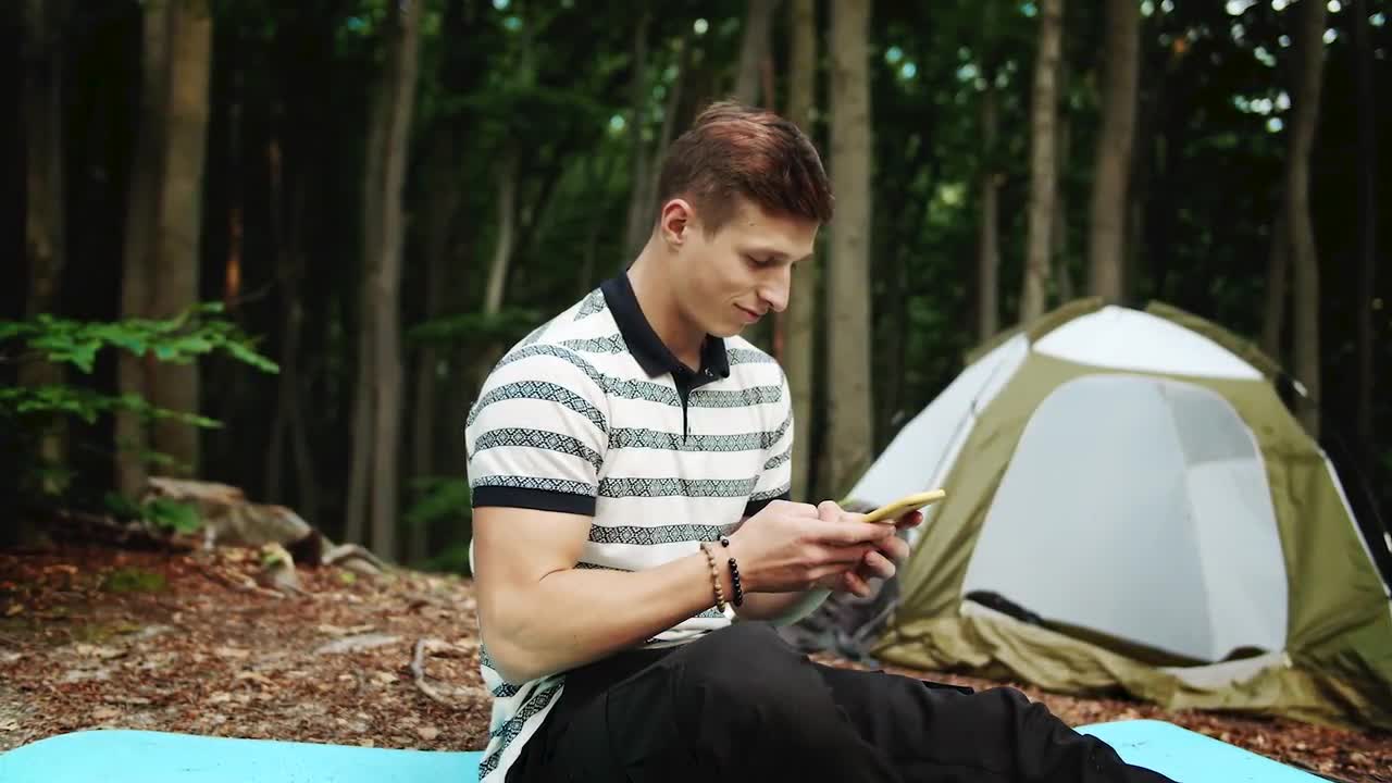 Using Phone At Campsite - Stock Video | Motion Array