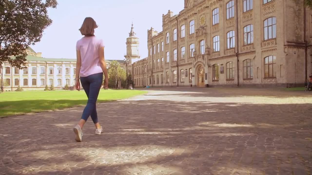 Student Walks Toward University - Stock Video | Motion Array