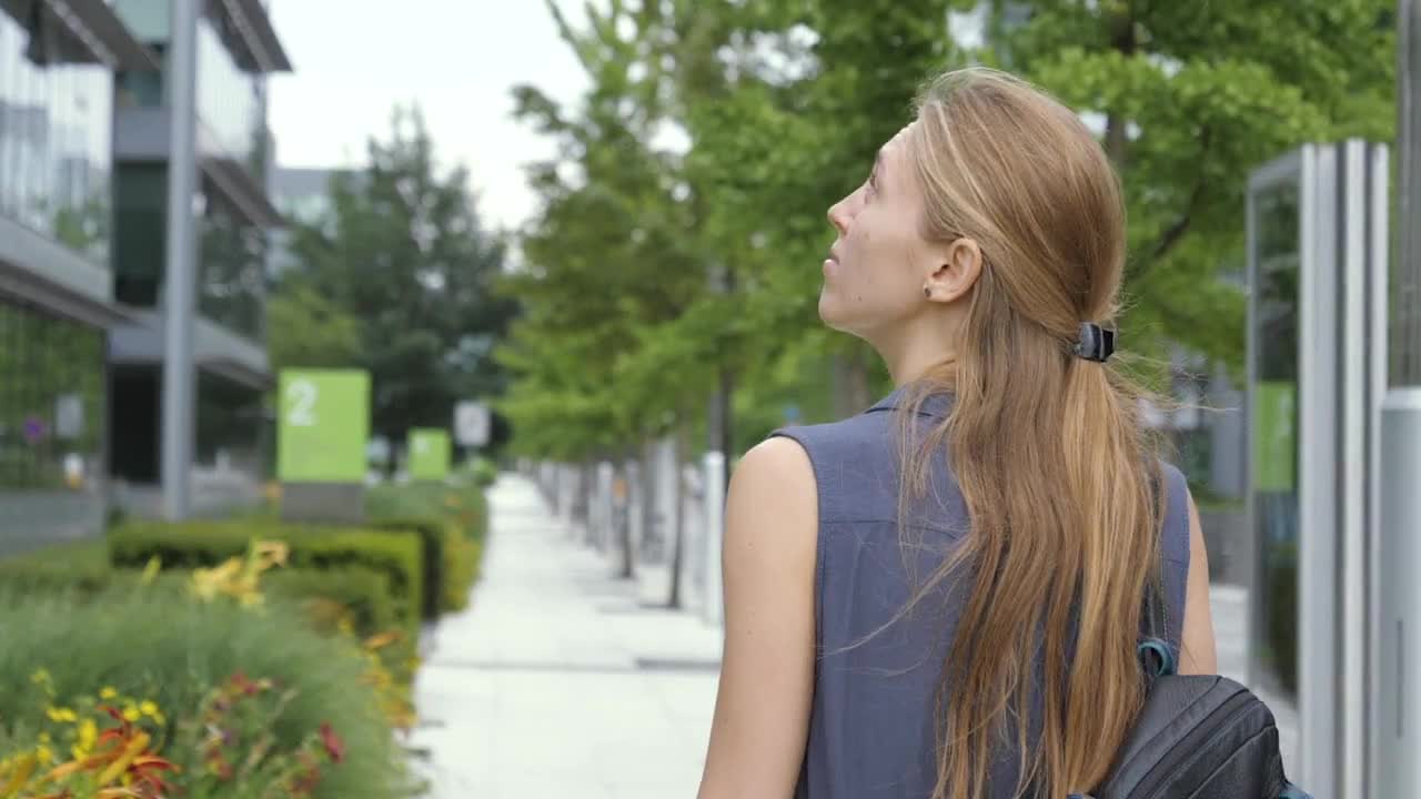 Woman Looking At Buildings - Stock Video | Motion Array