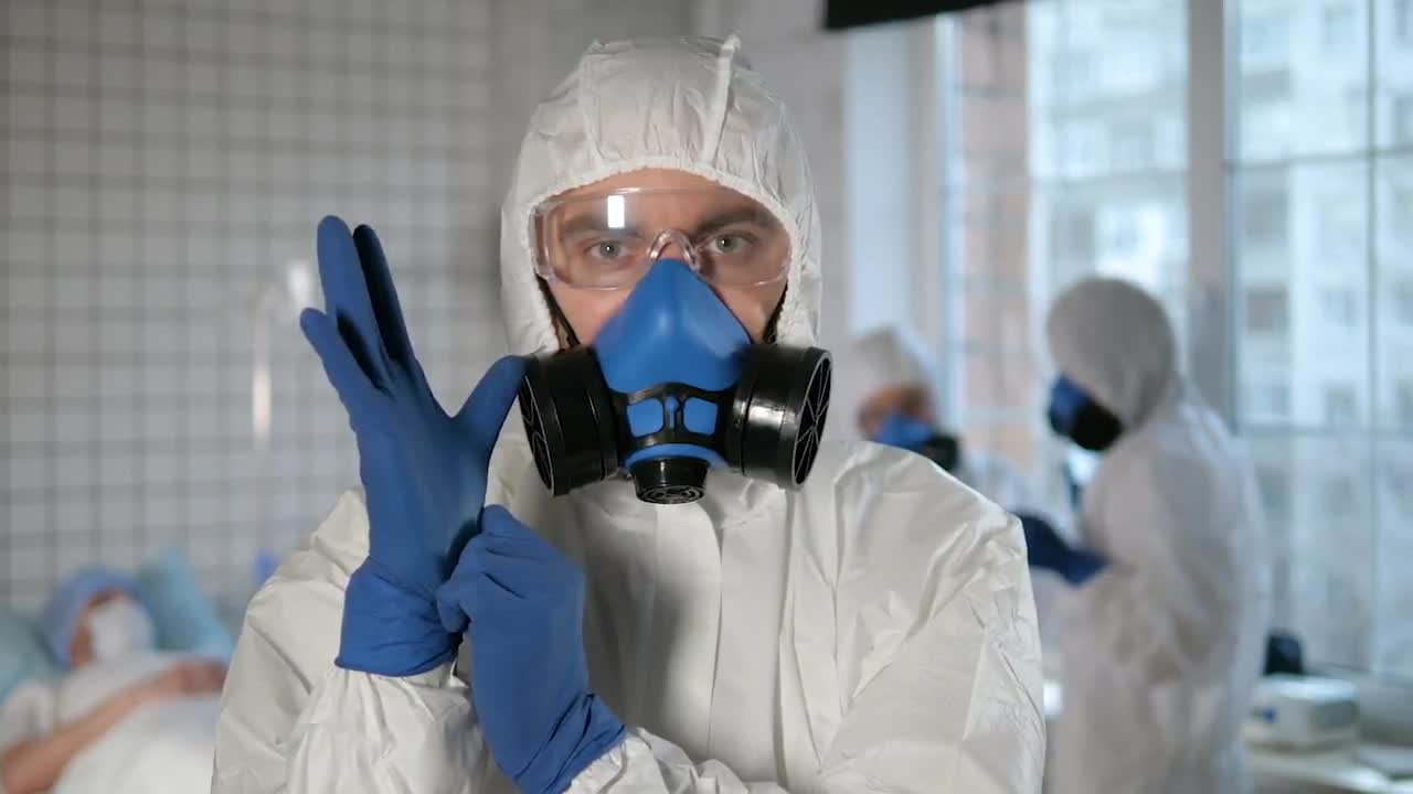 Man In A Biohazard Suit Explains - Stock Video | Motion Array