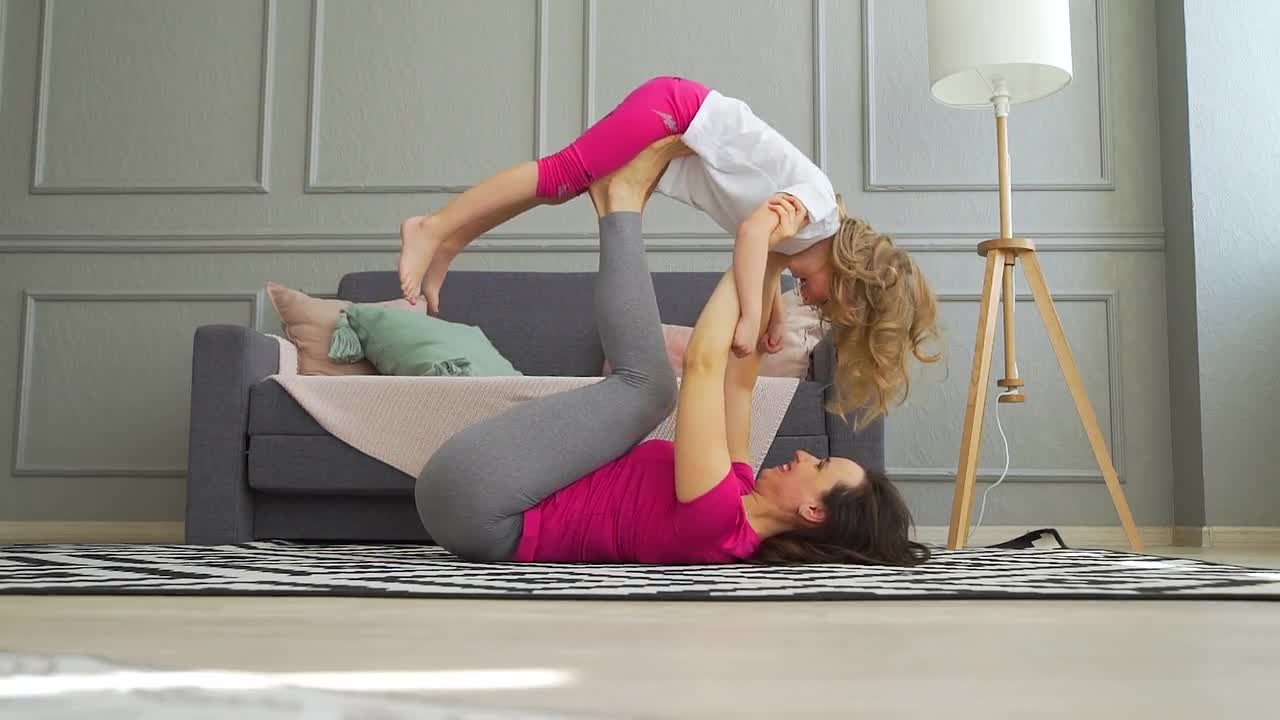 Mother Lifting Daughter - Stock Video | Motion Array