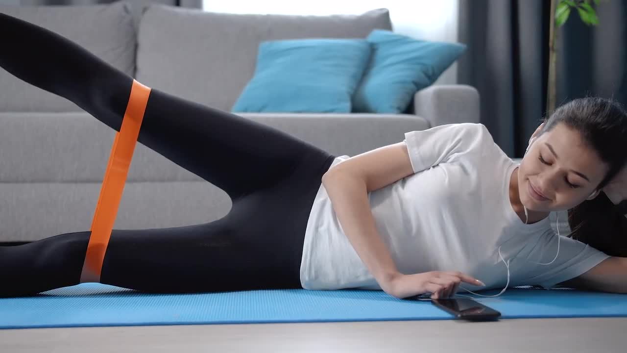 Elastic Band Leg Lifts At Home - Stock Video | Motion Array