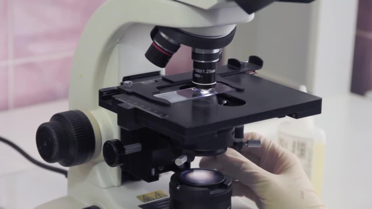 Scientist Adjusting Microscope Lens - Stock Video | Motion Array