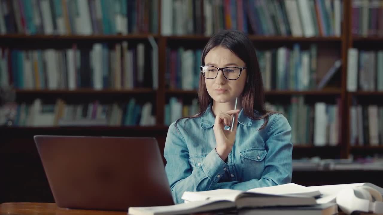 Using A Laptop Computer In A Library - Stock Video | Motion Array