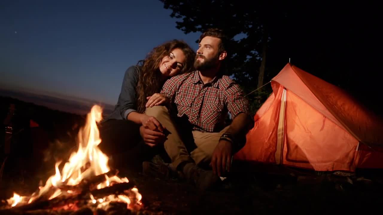 Couple Sitting By The Fire - Stock Video | Motion Array