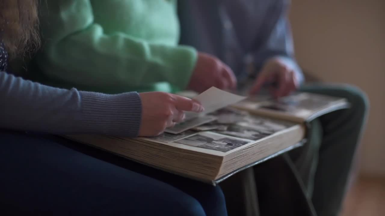 Family Looking Through Old Photo Album - Stock Video | Motion Array