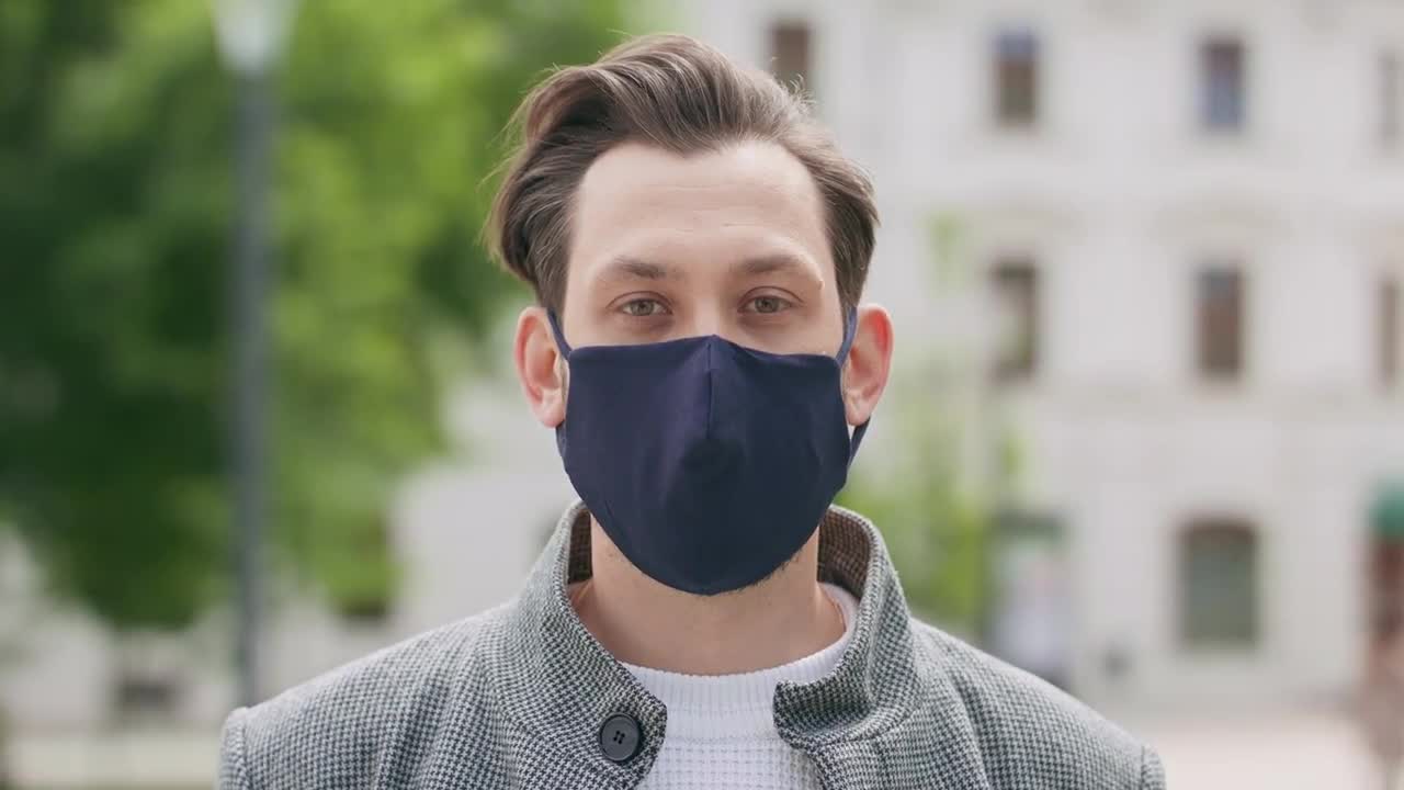 Man Puts On Mask Outdoors Close-Up - Stock Video | Motion Array