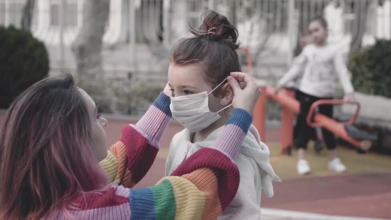 Mother Putting Mask On Daughter - Stock Video | Motion Array