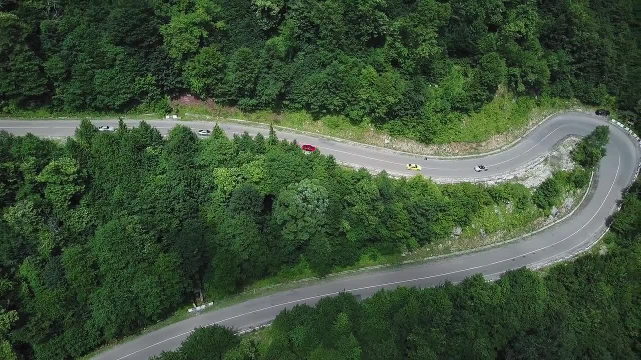 Sports Cars Approaching Sharp Turn - Stock Video | Motion Array