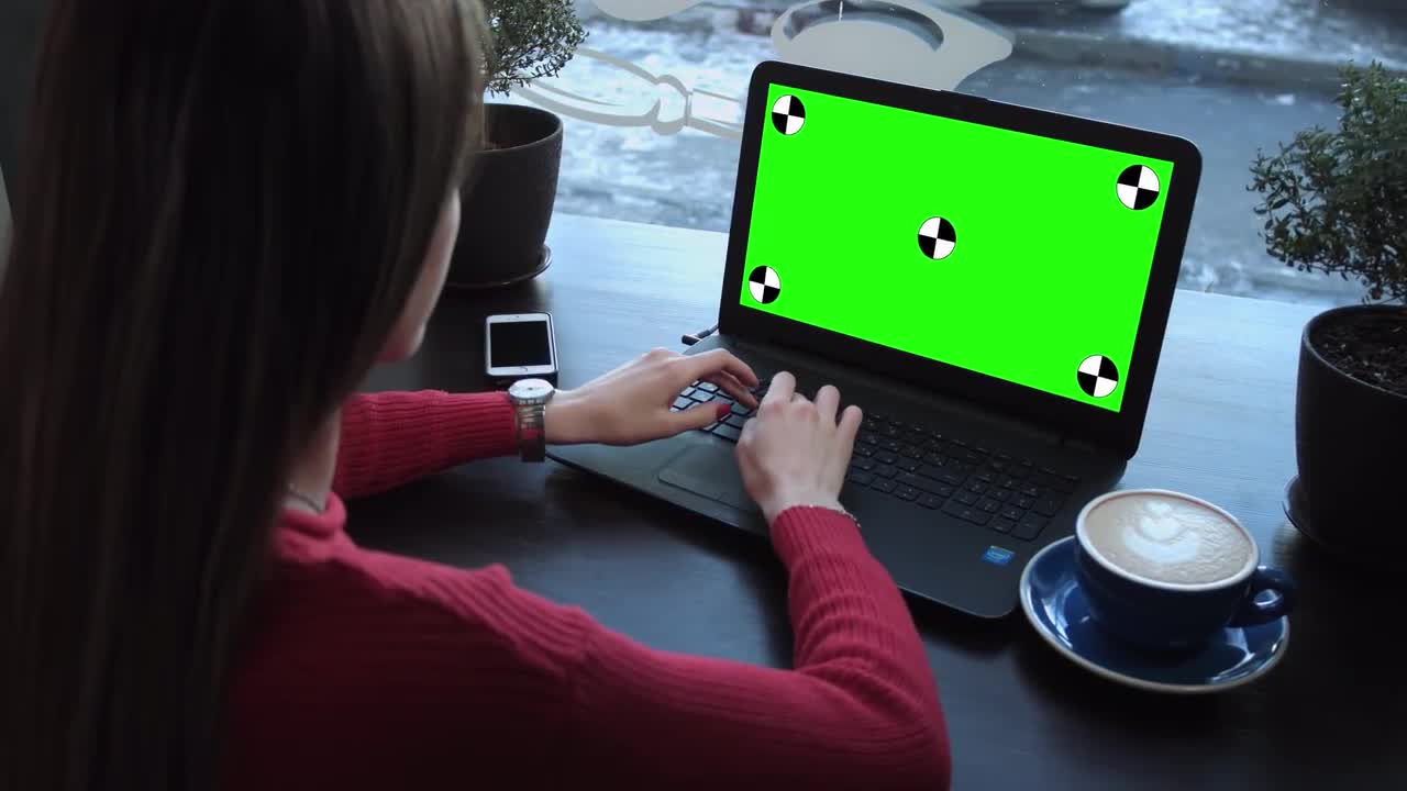 Woman With Green Screen In Coffee Shop - Stock Video | Motion Array