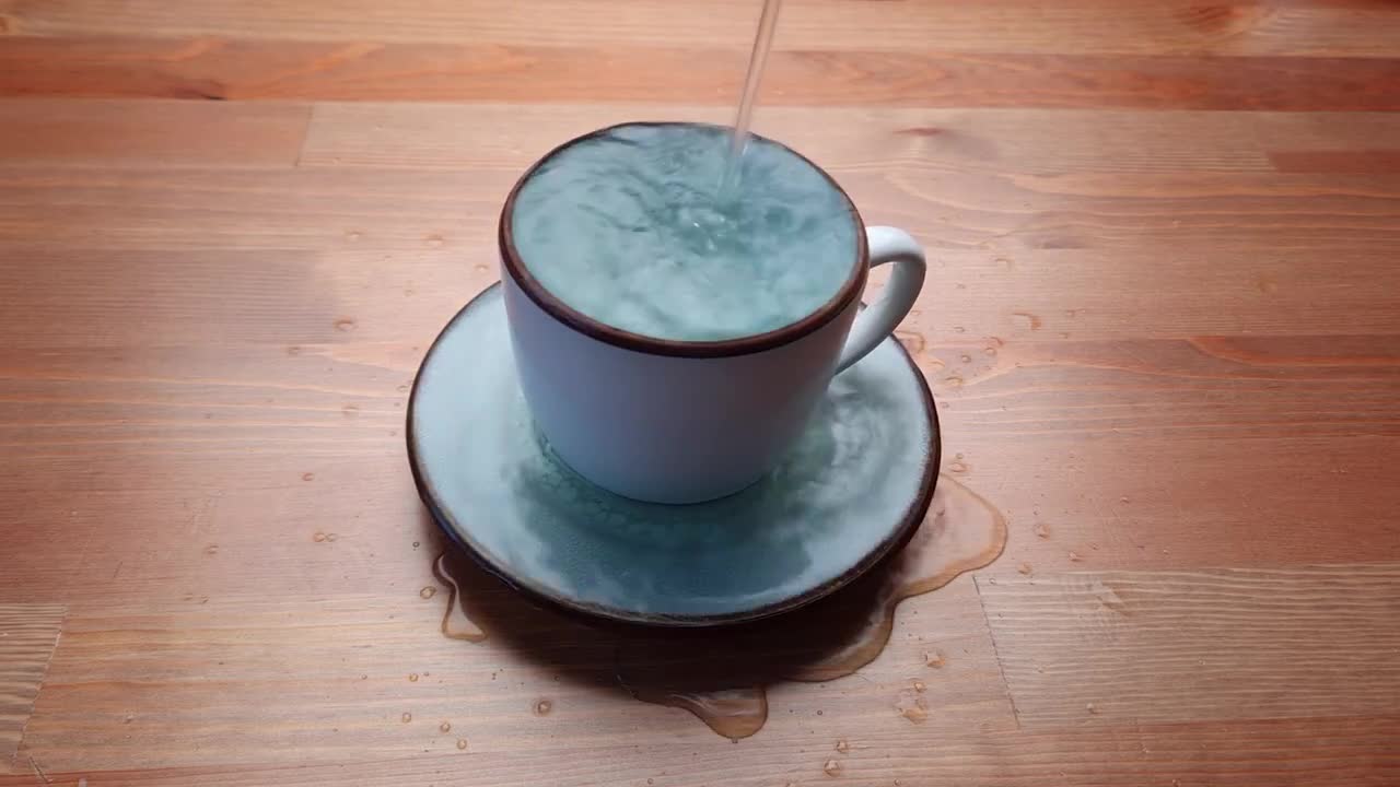 Water Overflowing Out Of Cup - Stock Video | Motion Array