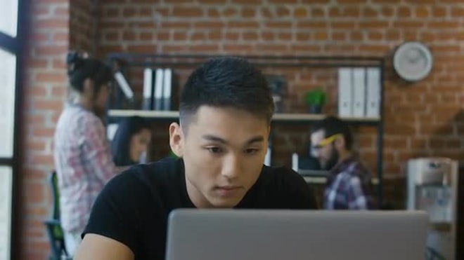 Asian Man Using A Computer - Stock Video | Motion Array
