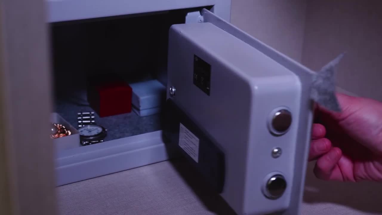 Woman Removing Jewelry From A Safe - Stock Video | Motion Array