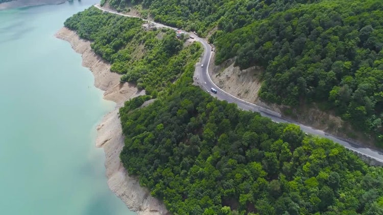 Aerial View of Cars Driving By A Lake - Stock Video | Motion Array