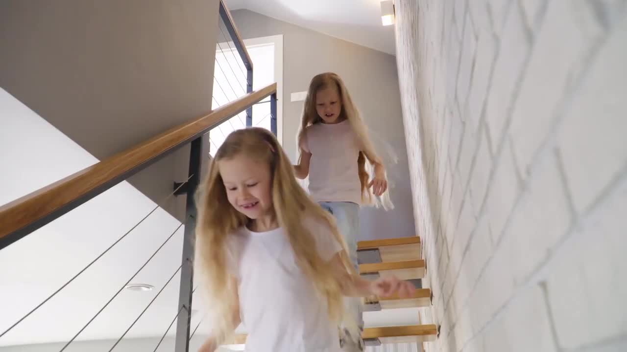Twin Sisters Running Down Stairs - Stock Video | Motion Array