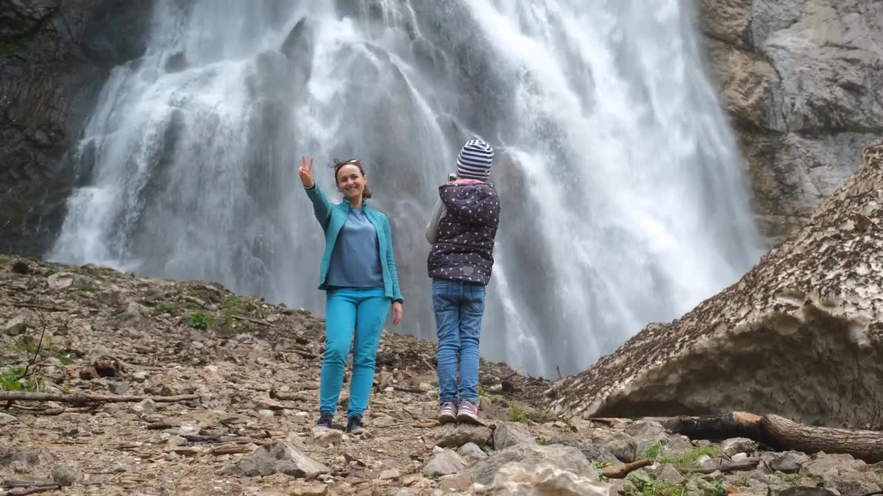 With Her Mother At The Waterfall - Stock Video | Motion Array